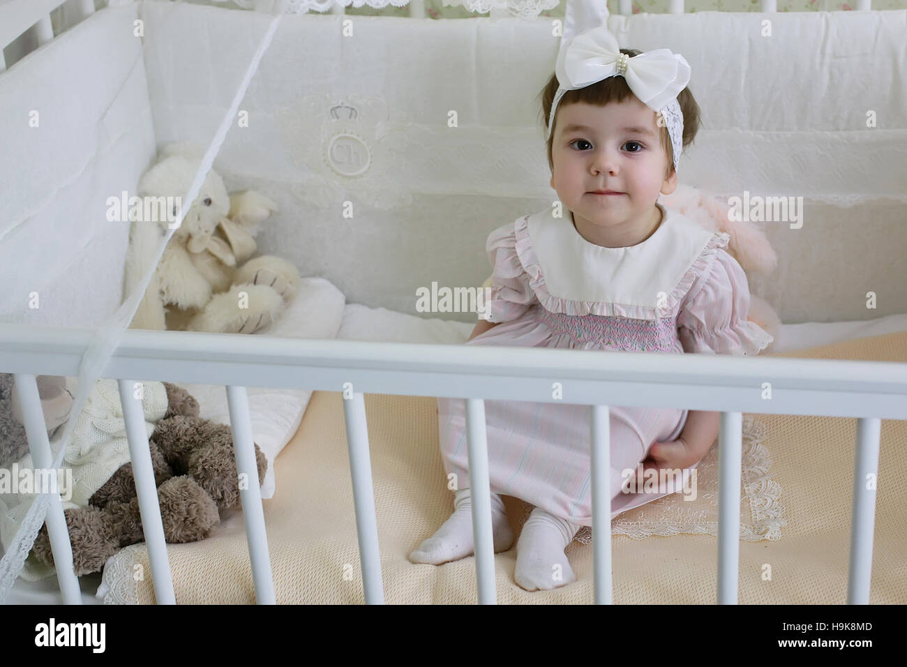 little kid sit in cot Stock Photo - Alamy