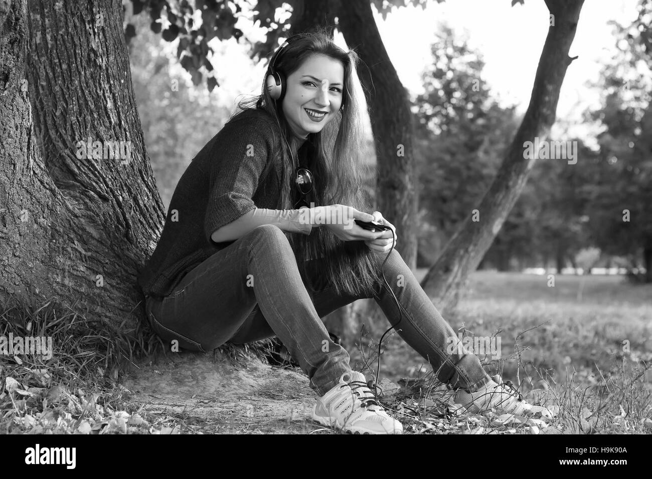 Girl autumn leaves casual player Stock Photo - Alamy