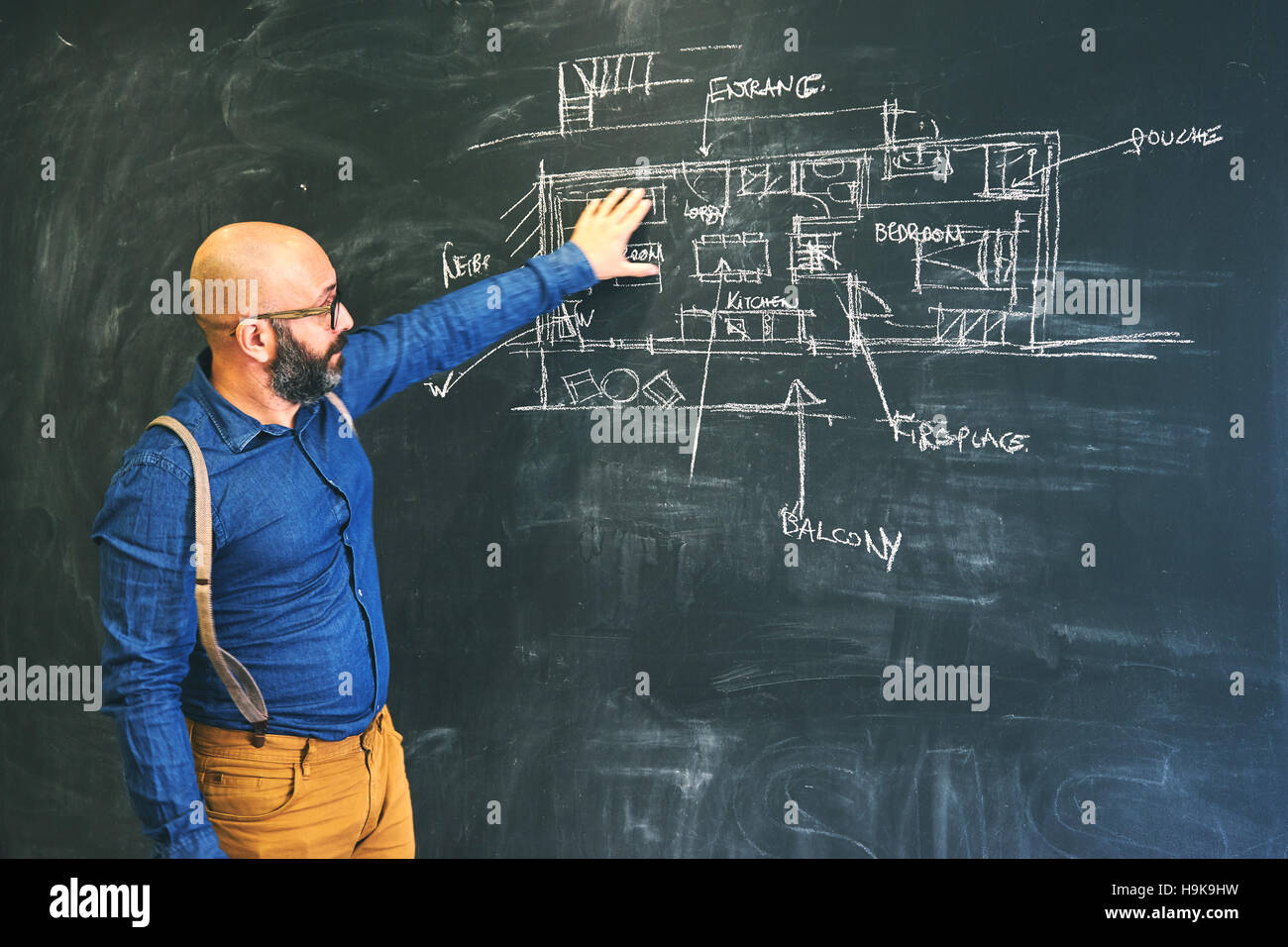 Architect man sketching new project on chalkboard Stock Photo - Alamy
