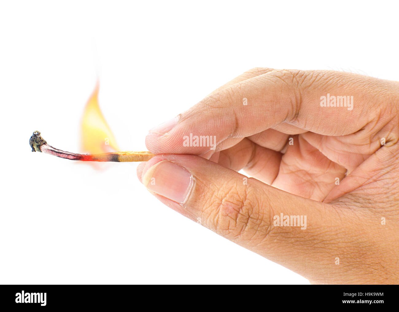 Hand holding a fired matchstick on a white background Stock Photo - Alamy