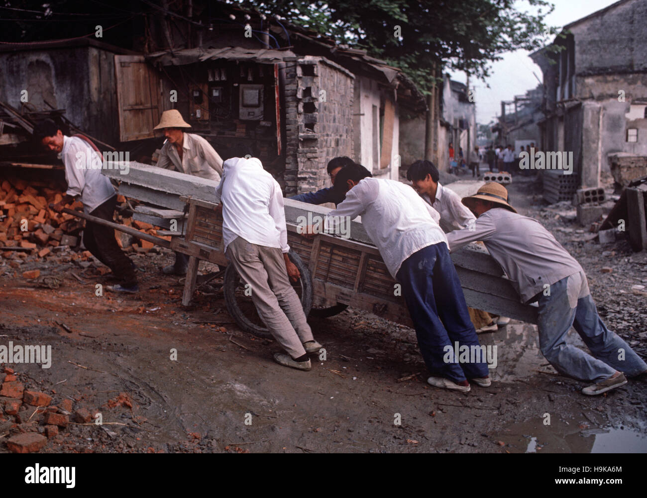Men hauling heavy concrete slab for building construction, Hangzhou ...