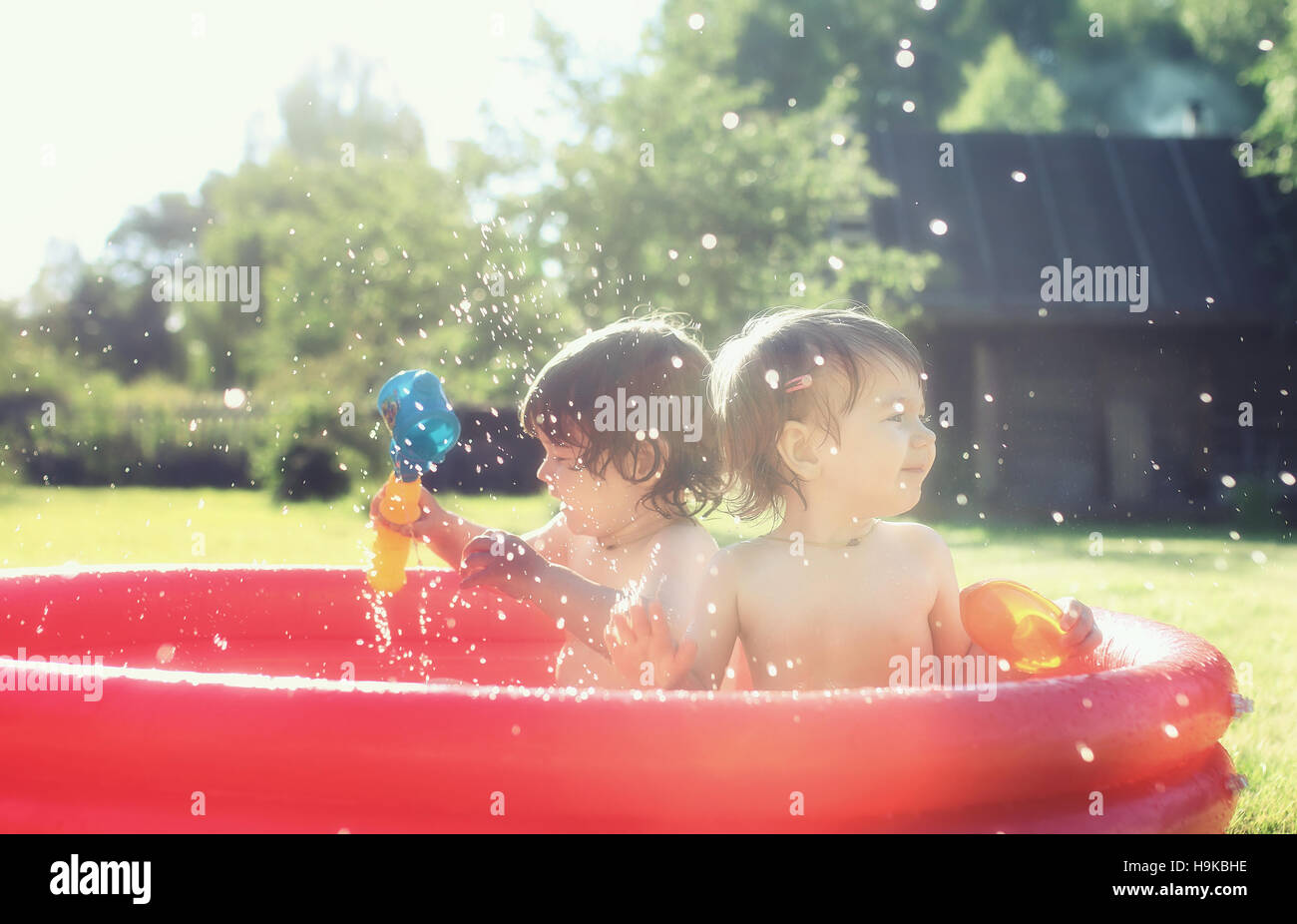 baby splashing in the pool outdoors Stock Photo - Alamy