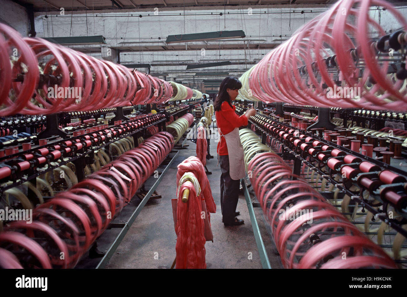 Spools of silk being put on to bobbins ready for weaving in the Chinese ...