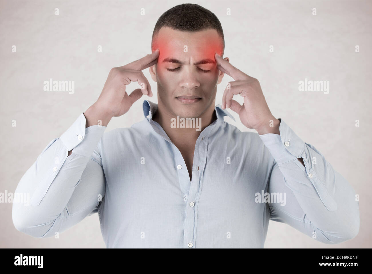 Man suffering from an headache, holding his hand to the head, isolated ...