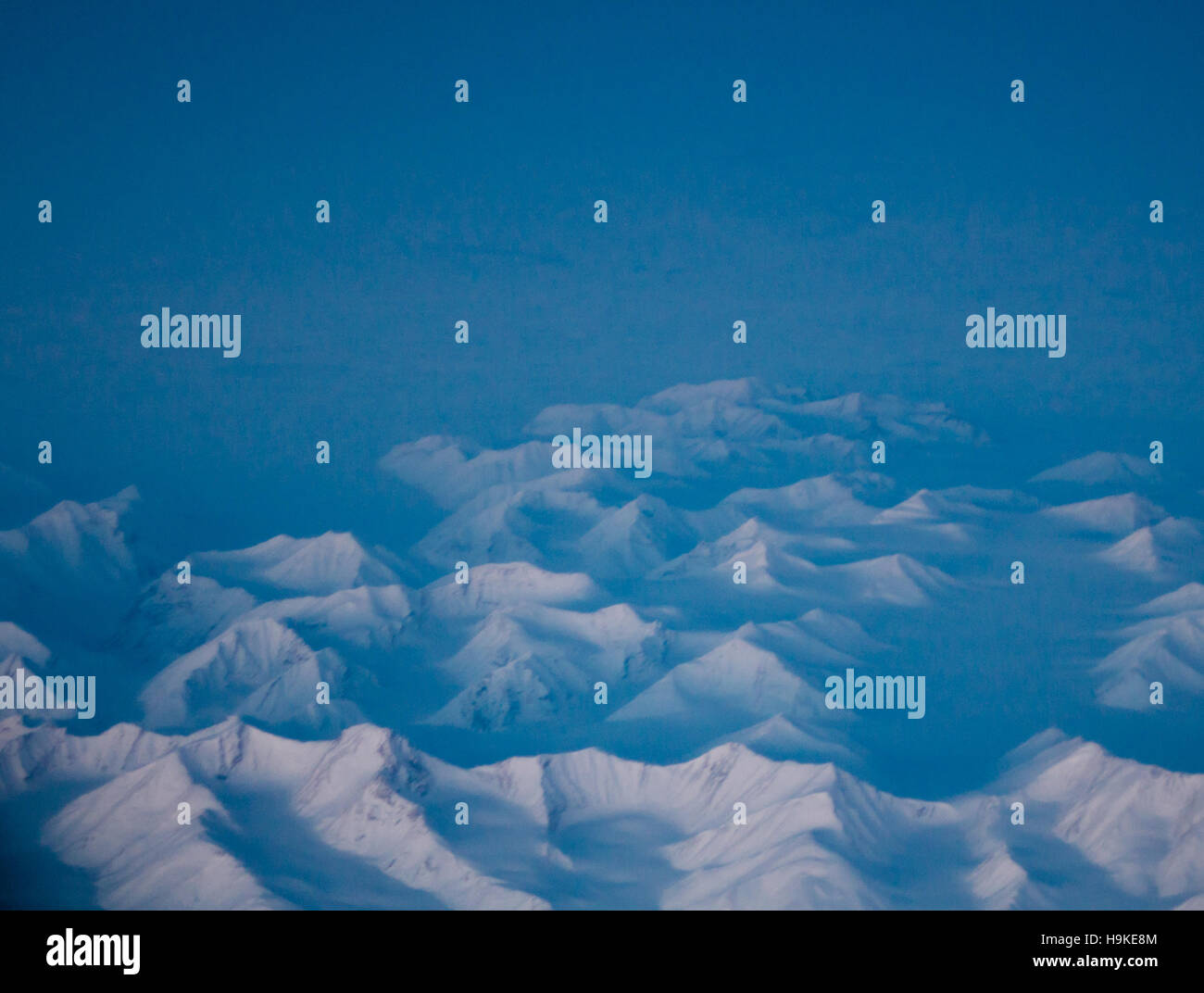 Snow and ice covered mountains of Greenland from the air Stock Photo ...