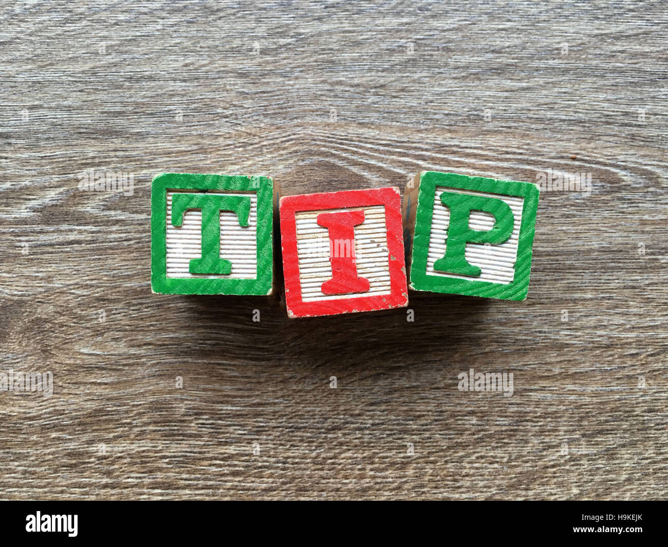 Alphabet wood blocks making the word TIP Stock Photo - Alamy