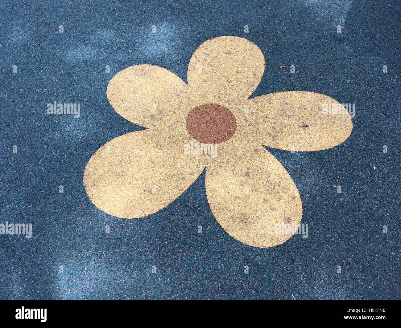 Yellow Flower painted on soft playground floor Stock Photo - Alamy