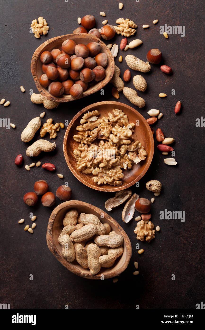 Various nuts on stone table. Top view Stock Photo - Alamy
