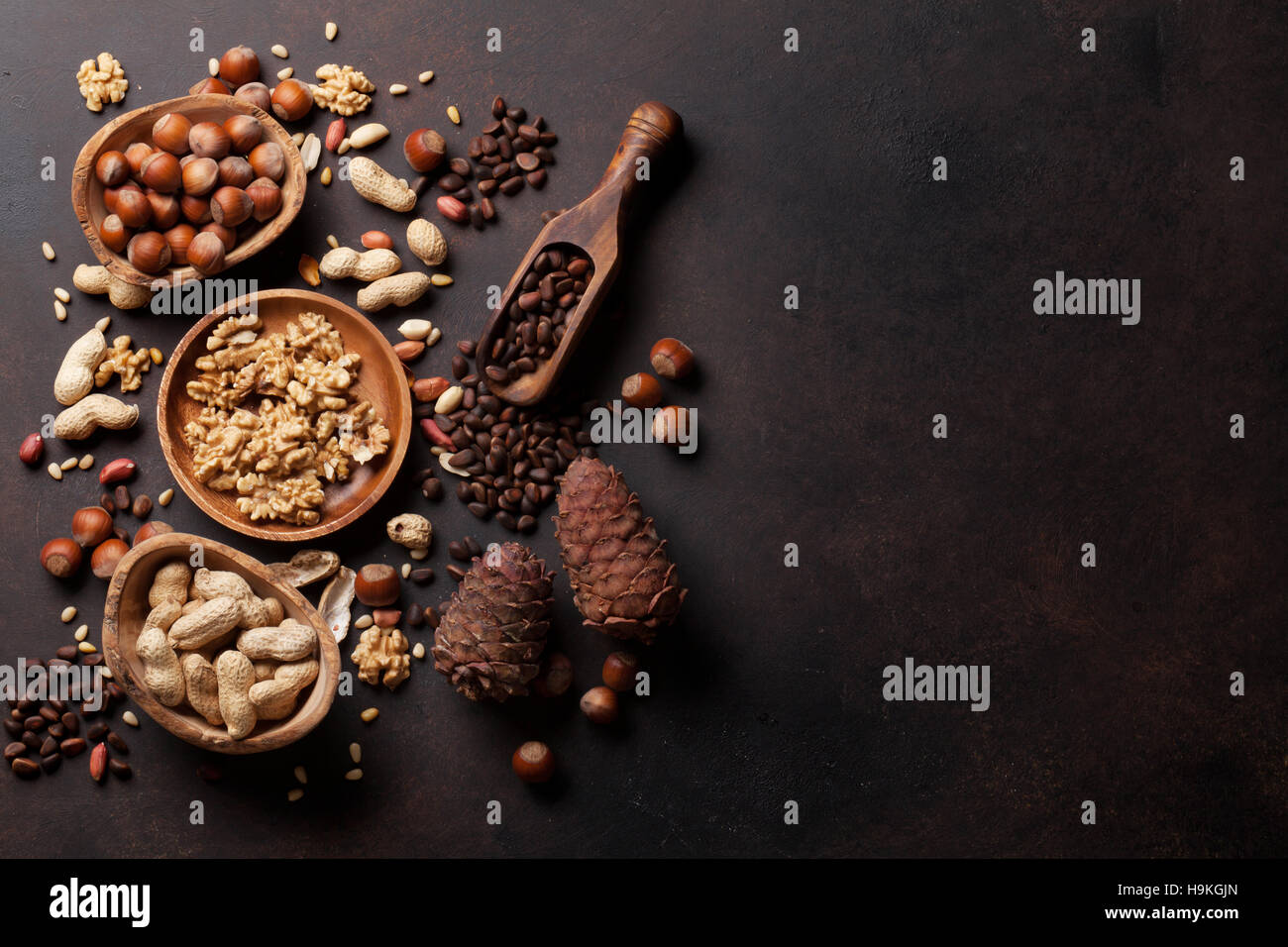 Various nuts on stone table. Top view with copy space Stock Photo - Alamy
