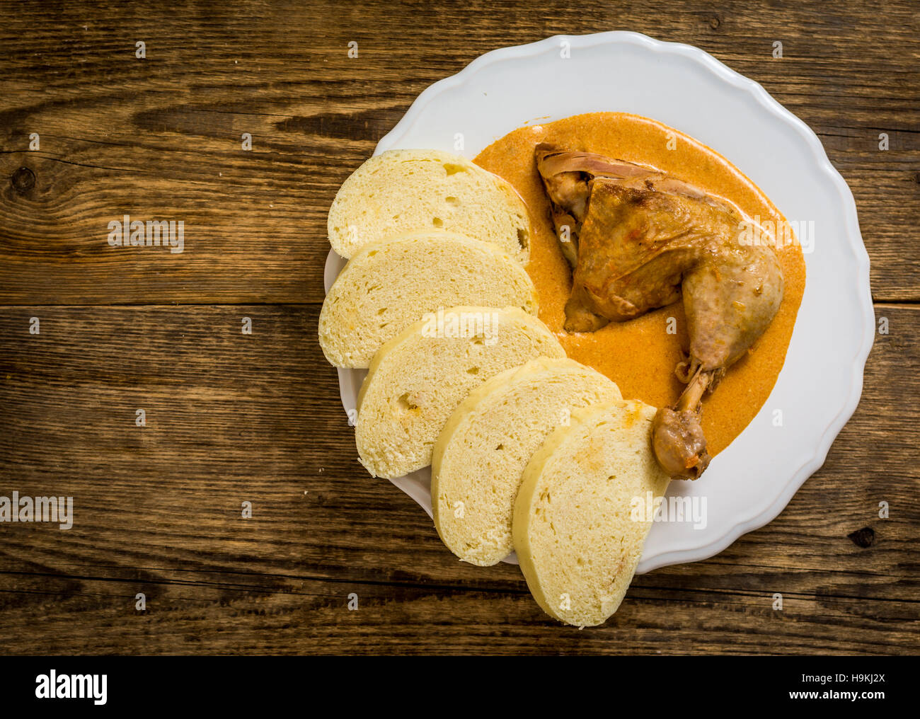 Traditional Czech cuisine chicken thigh on red pepper sauce with ...