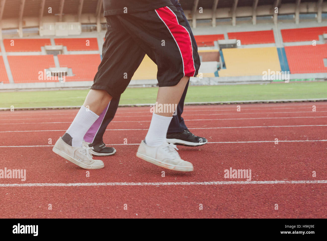 Two runners sprinting outdoors Sportive people training in a urban area ...