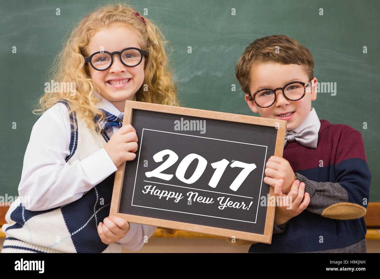 School kids holding chalkboard with new year text Stock Photo - Alamy