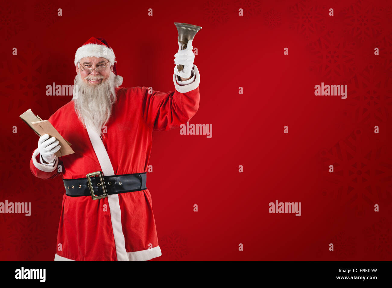 Composite image of santa claus holding bible and bell Stock Photo - Alamy