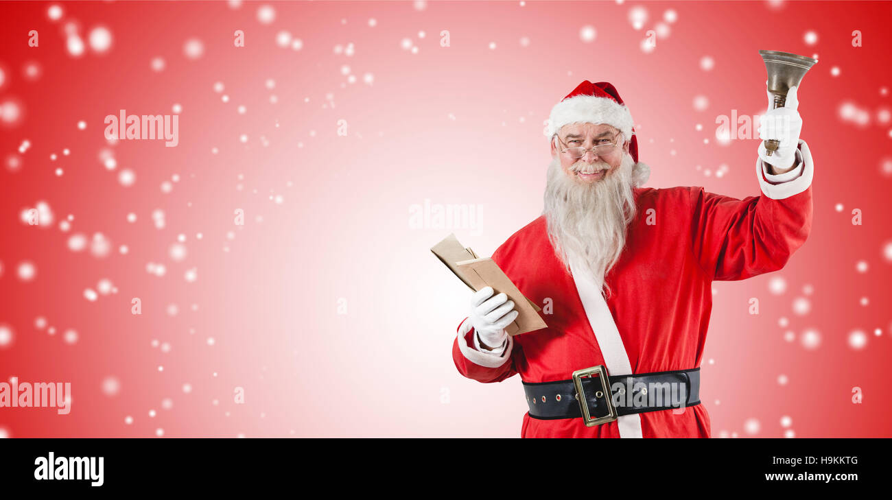 Composite image of santa claus holding bible and bell Stock Photo - Alamy