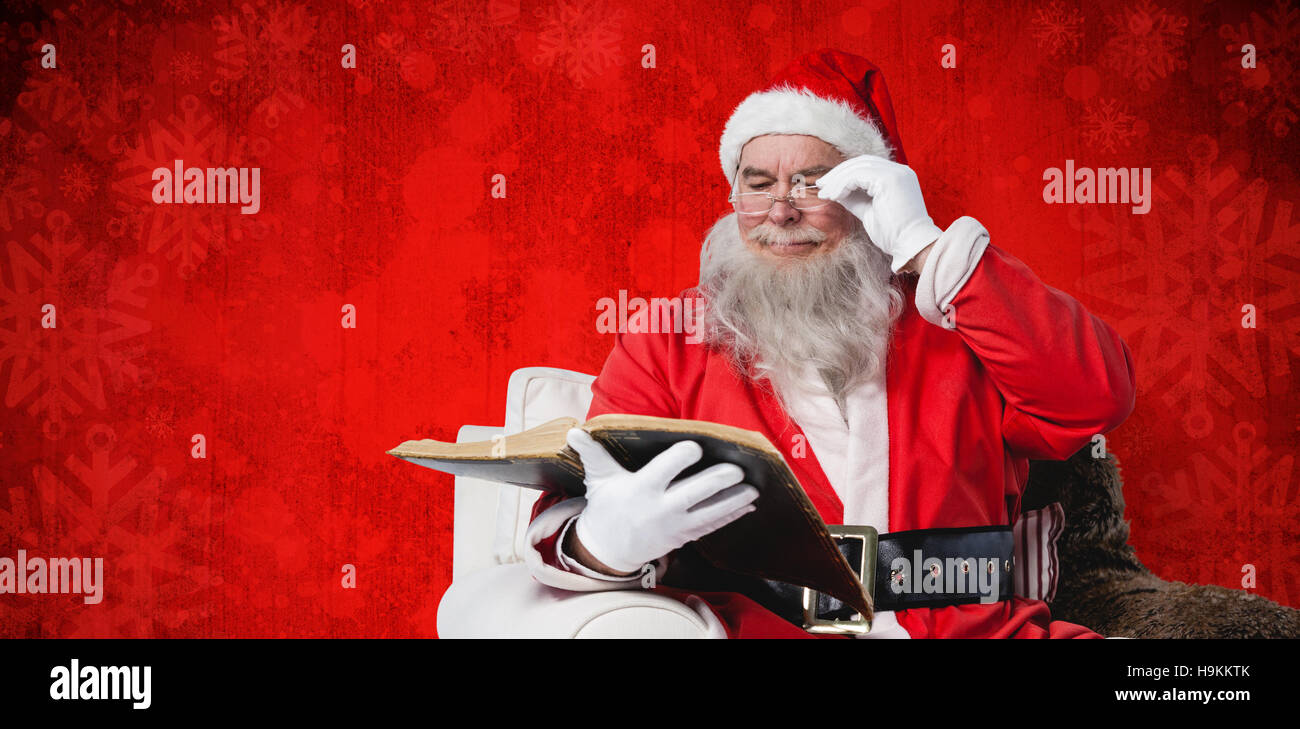 Composite image of santa claus reading bible on armchair Stock Photo ...