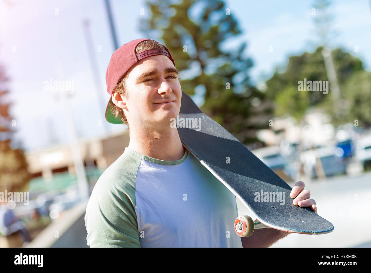 Handsome guy with skateboard Stock Photo - Alamy