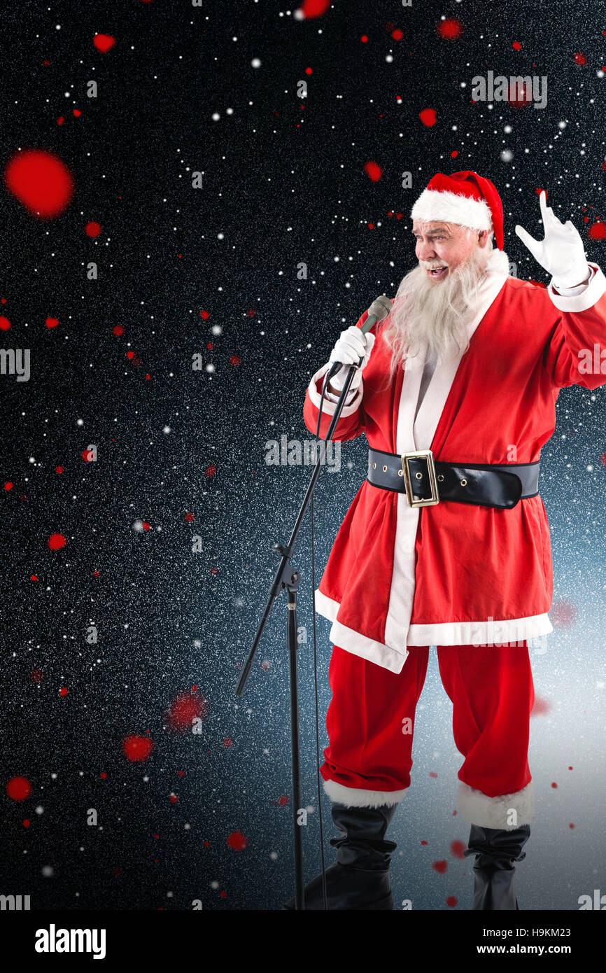Composite image of santa claus singing christmas songs Stock Photo - Alamy