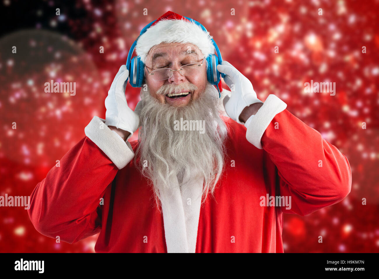 Composite image of santa claus listening music on headphones Stock ...