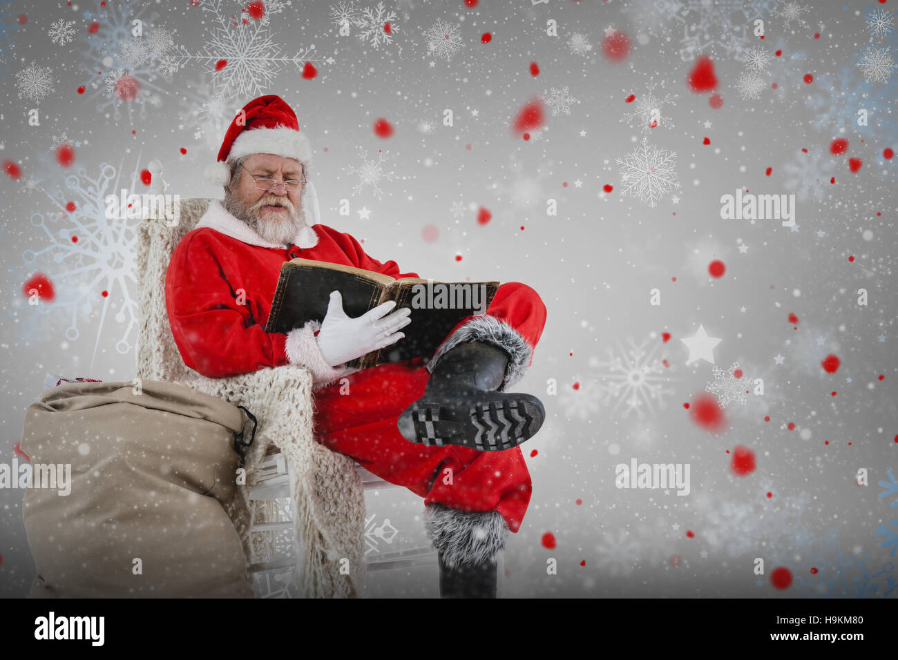 Composite image of santa claus reading bible with sack of christmas ...