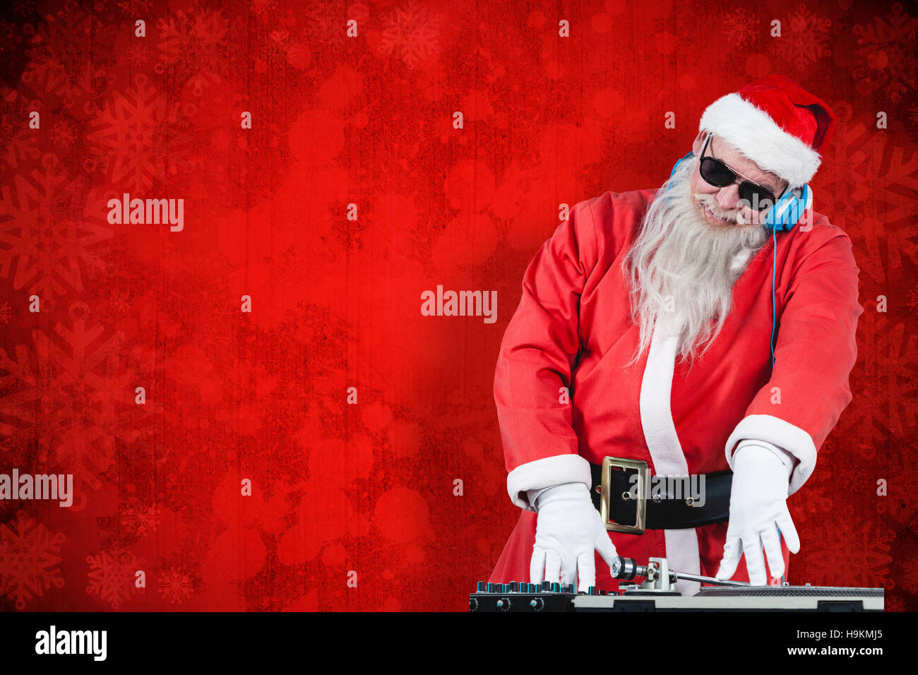 Composite image of dj santa claus mixing sound Stock Photo - Alamy