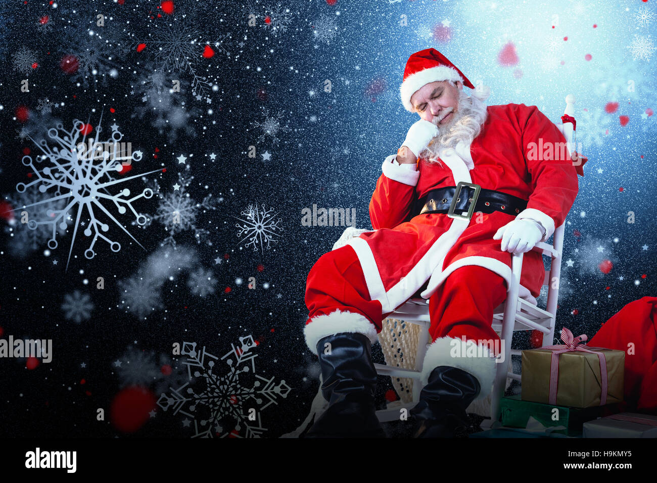Composite image of santa claus relaxing on chair Stock Photo - Alamy