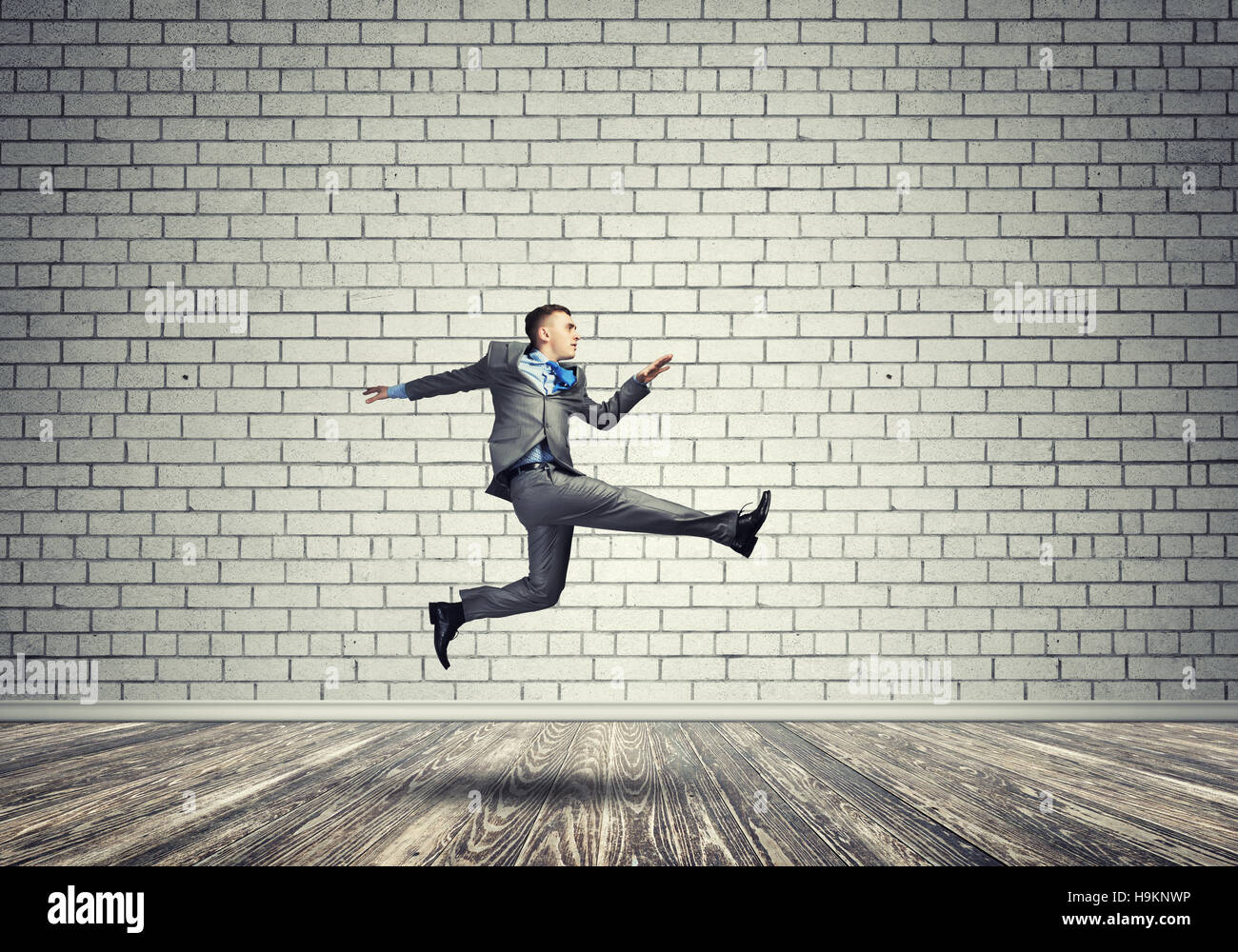 Businessman jumping high Stock Photo - Alamy