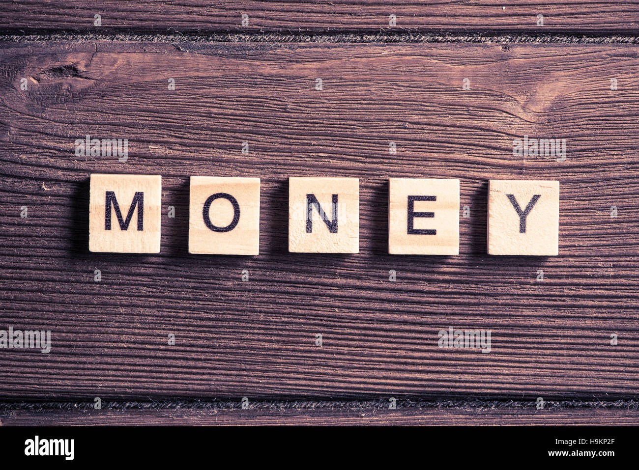 wooden elements with letter collected word money Stock Photo - Alamy