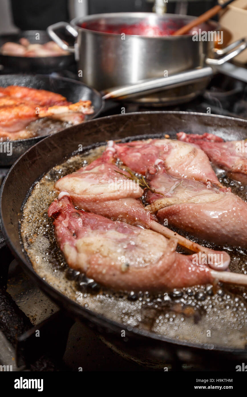 Goose drumstick frying in a pan, restaurant kitchen Stock Photo - Alamy