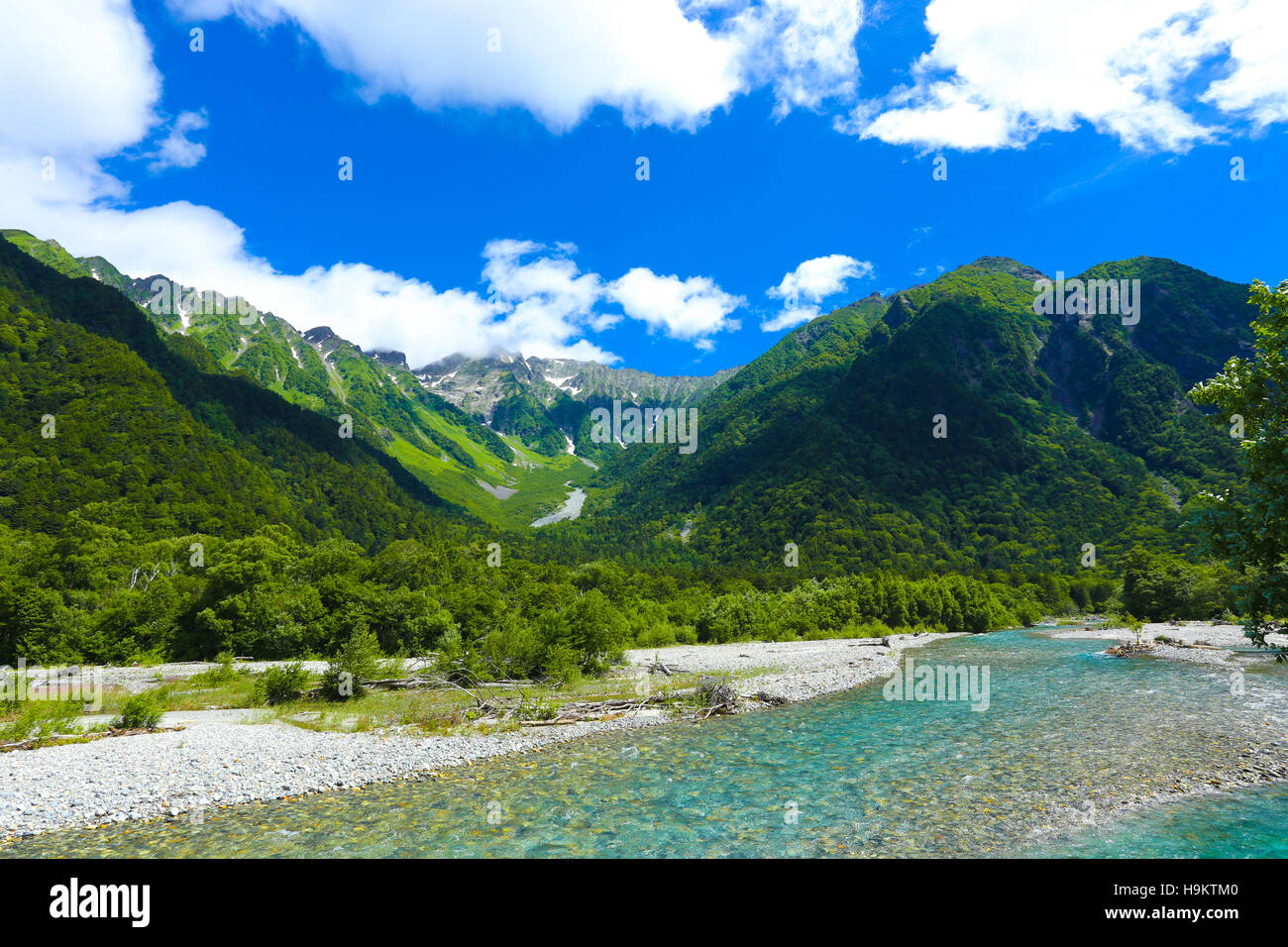 Pristine, crystal clear Azusa river flowing below snow capped Hotaka ...
