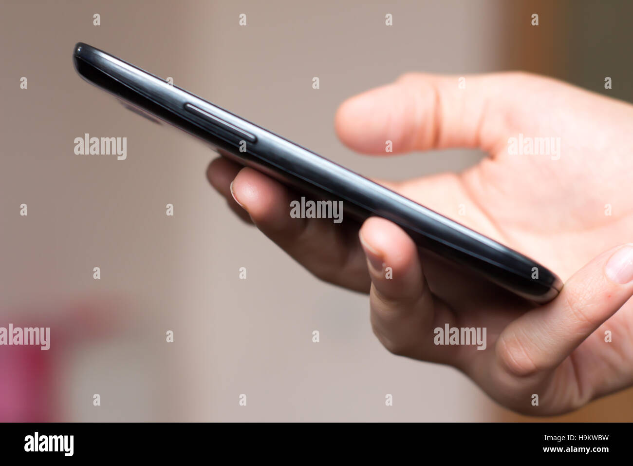 Closeup of young boys hand using smartphone Stock Photo - Alamy