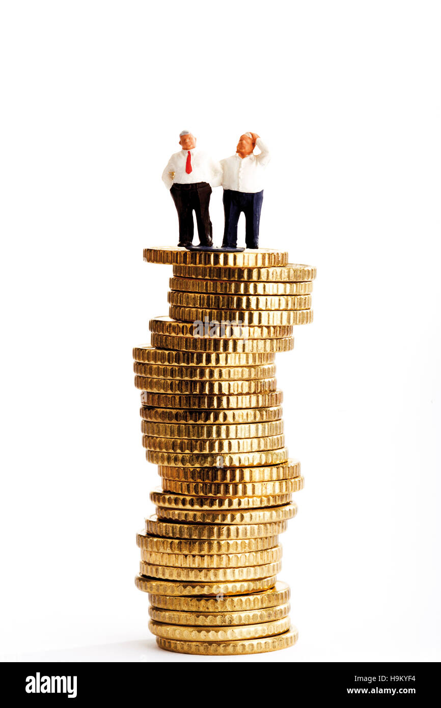Figurines of two heavy men on a stack of coins Stock Photo - Alamy