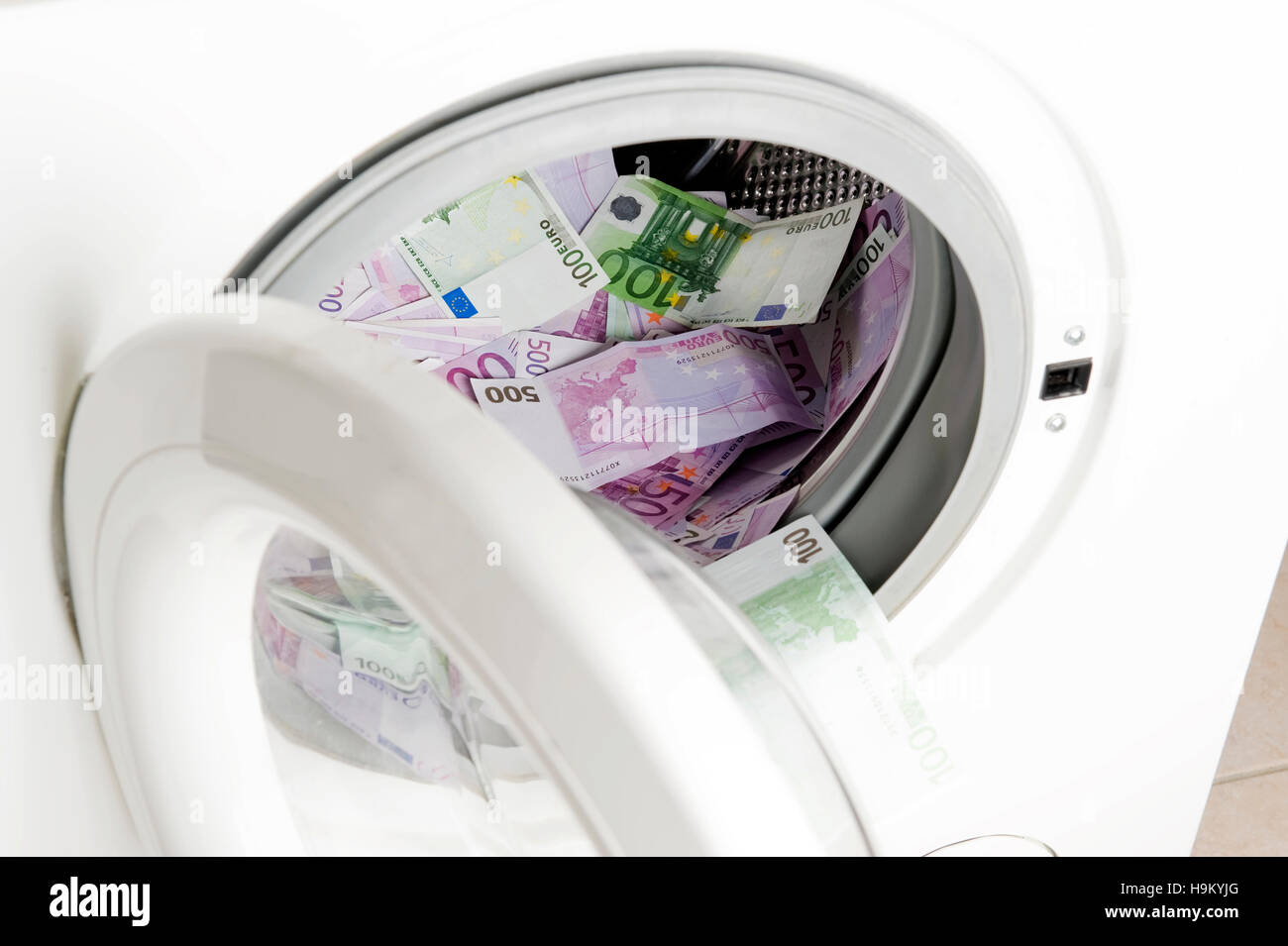 Euro banknotes in a washing machine, symbolic of money laundering Stock ...