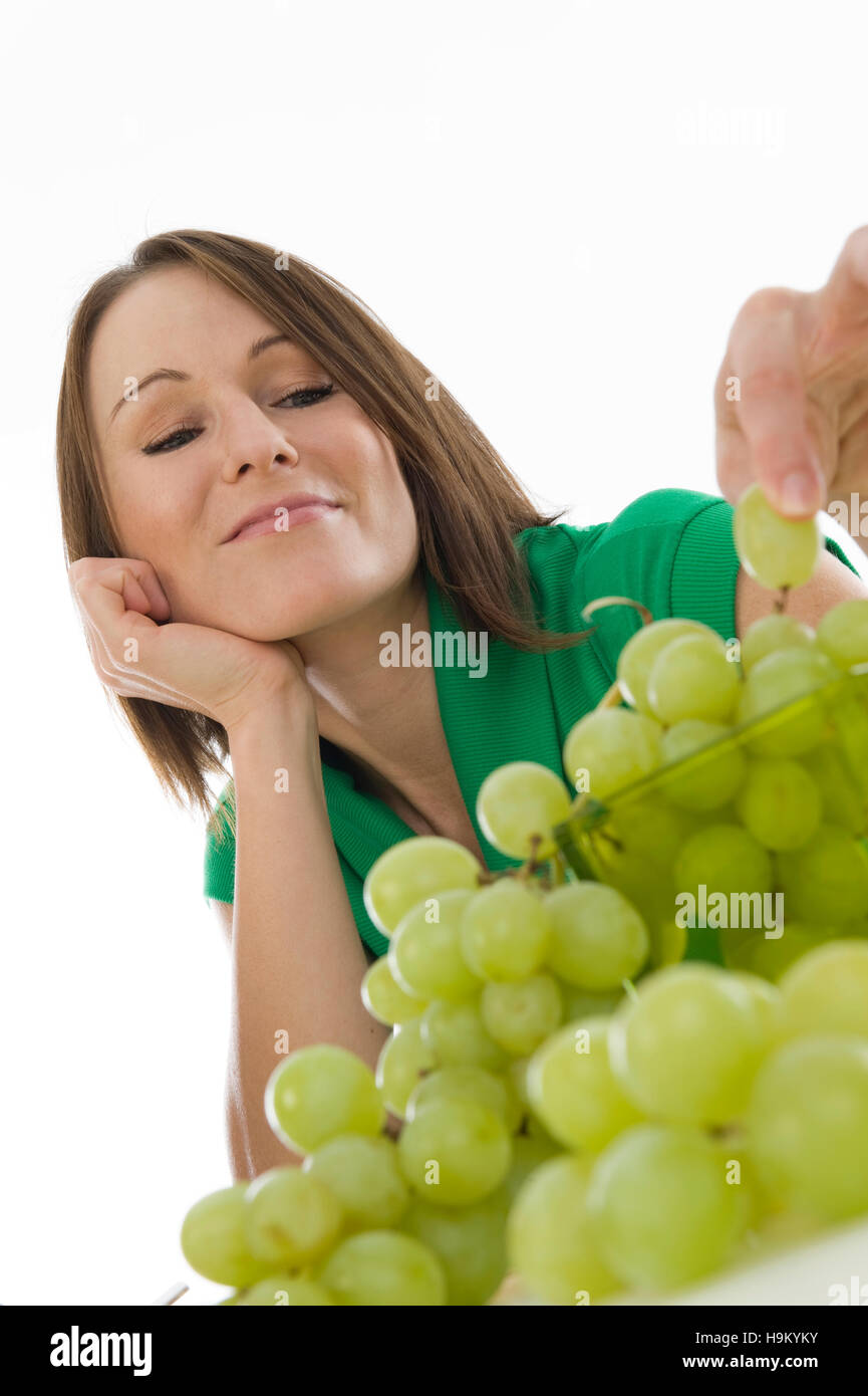 Young woman eating grapes Stock Photo - Alamy