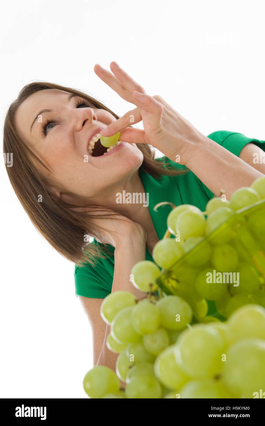 Young woman eating grapes Stock Photo - Alamy