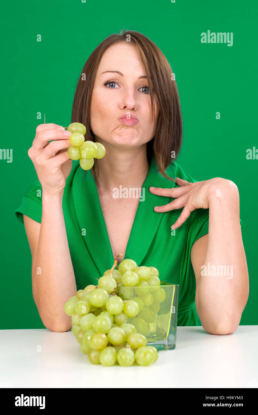 Young woman eating grapes Stock Photo - Alamy