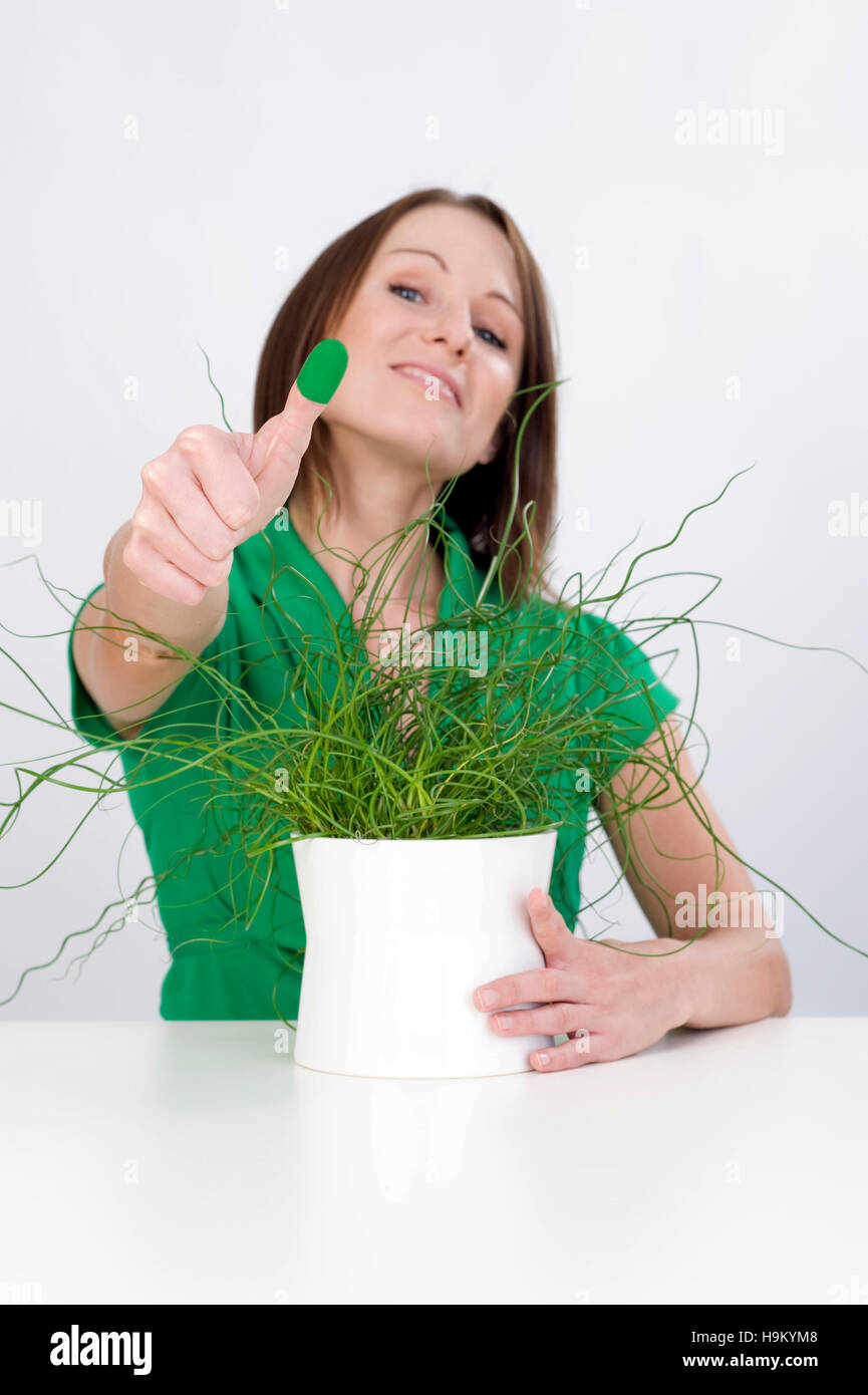 Young woman with green thumb, symbolic of green fingers Stock Photo - Alamy