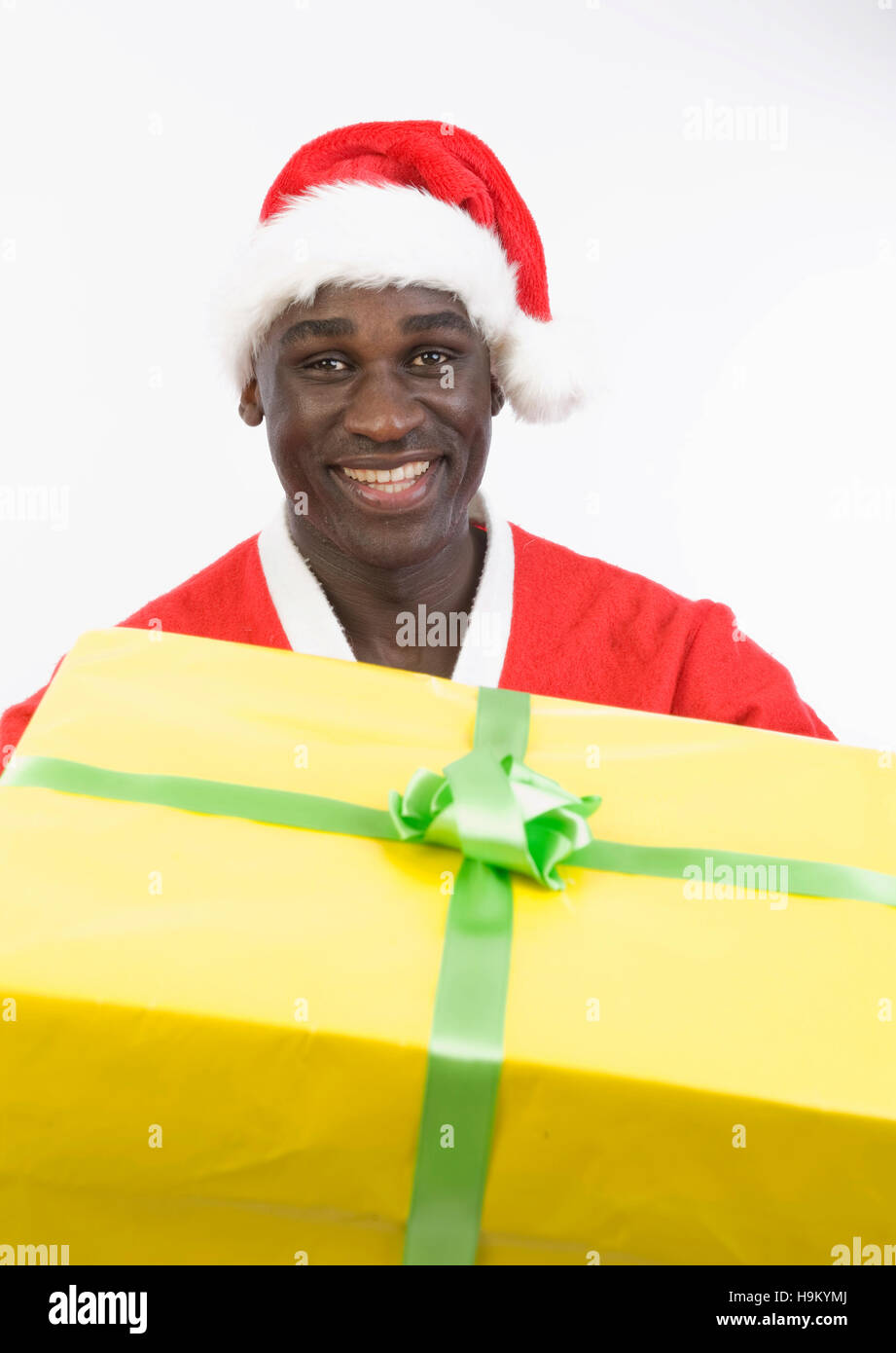 Dark-skinned Santa Claus with present Stock Photo - Alamy