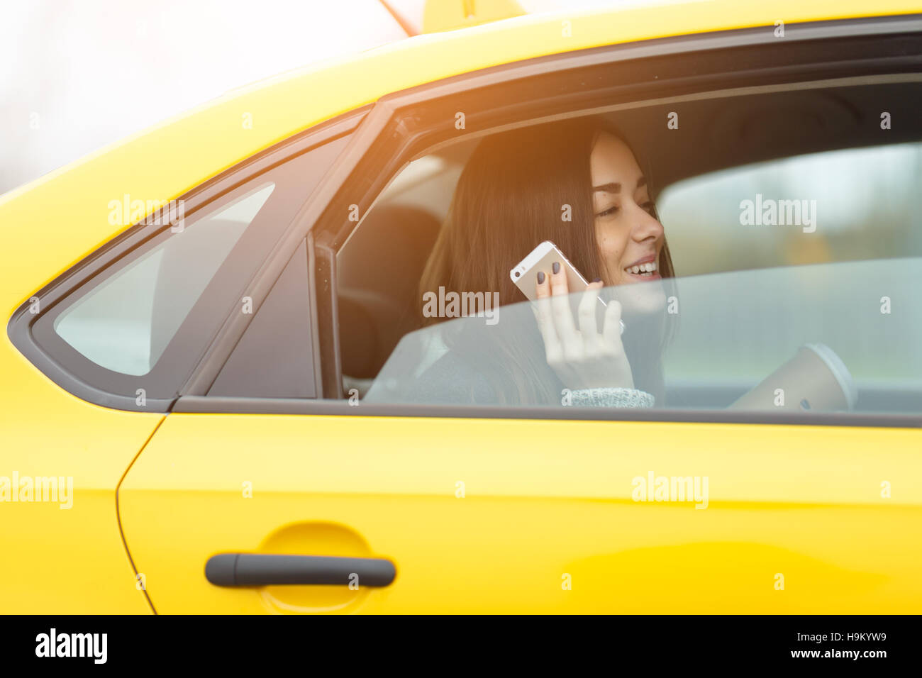 Girl sitting in yellow cab Stock Photo - Alamy