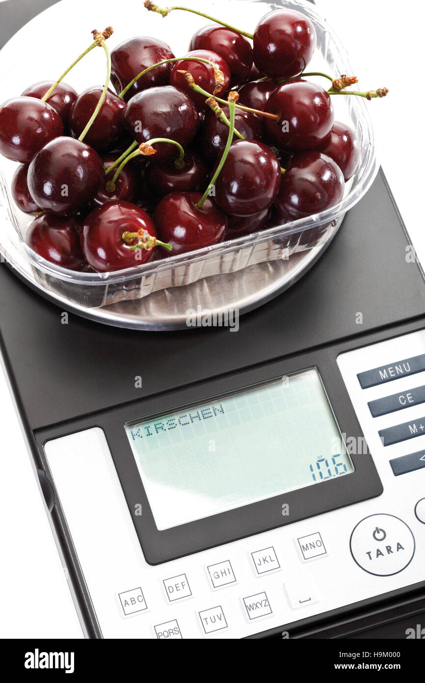 Sour cherries in a plastik box on a weighing scale Stock Photo - Alamy