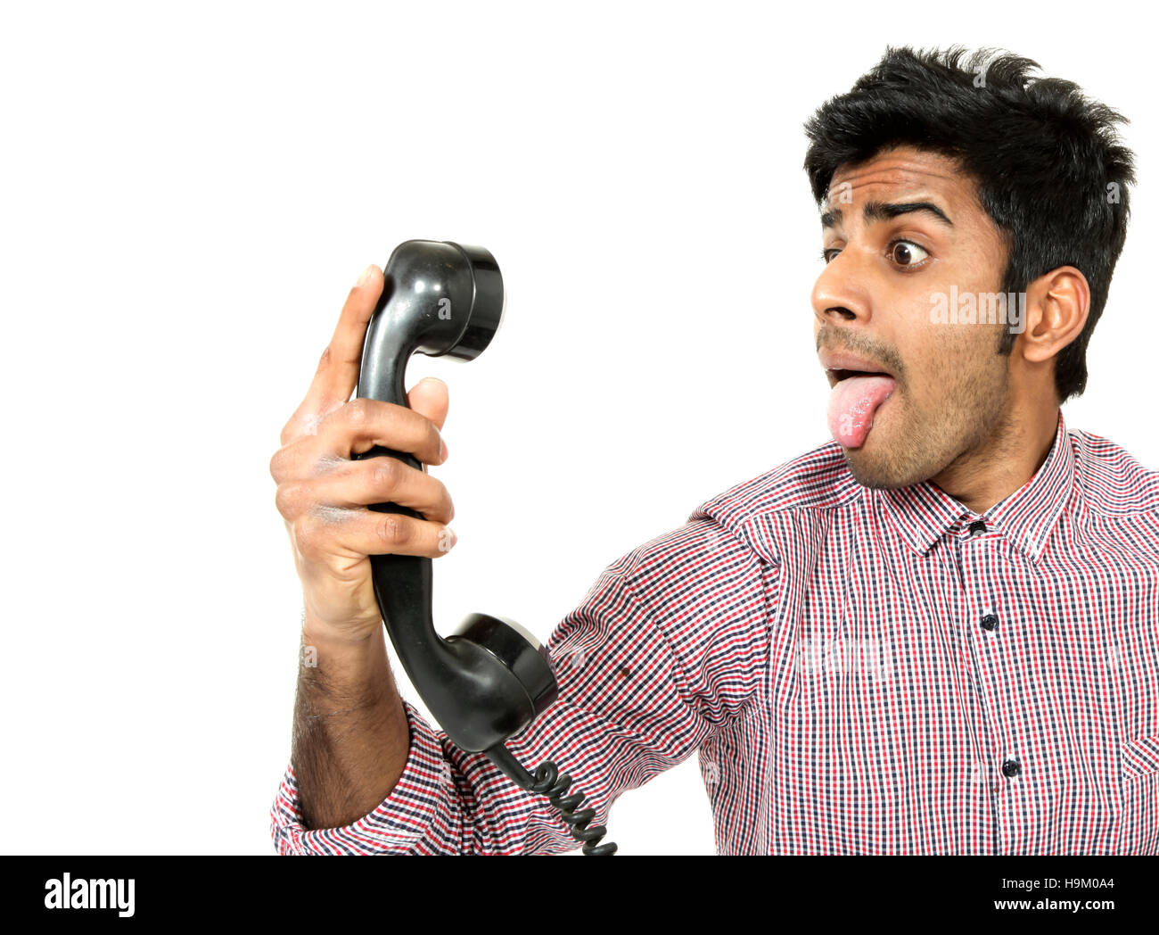 young man struggling with a crazy telephone , portrait on white ...