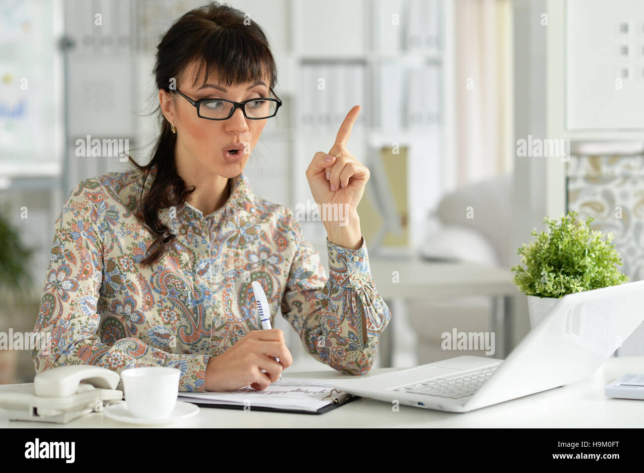 Exited woman with laptop Stock Photo - Alamy