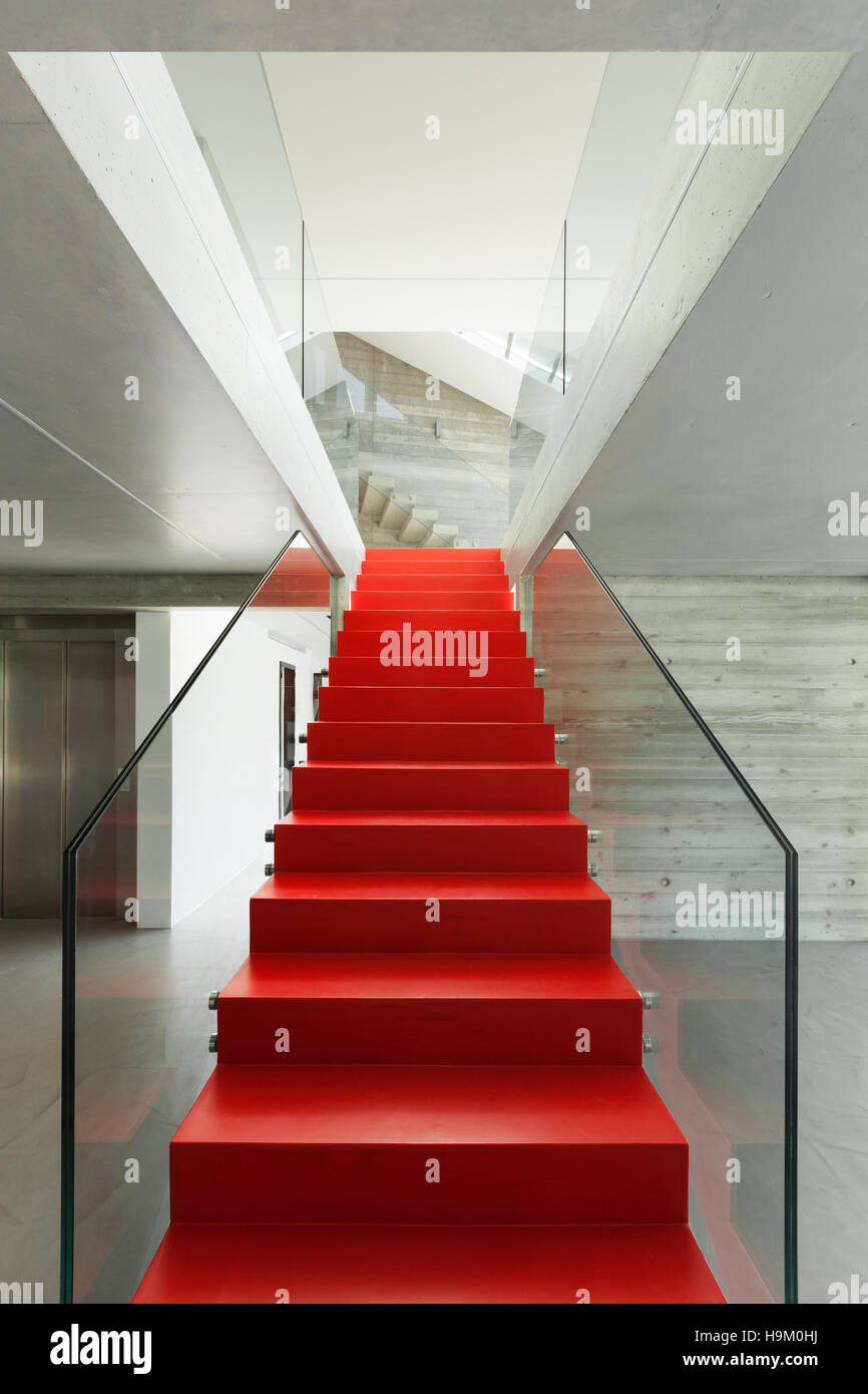 Interior, red staircase in modern villa Stock Photo - Alamy