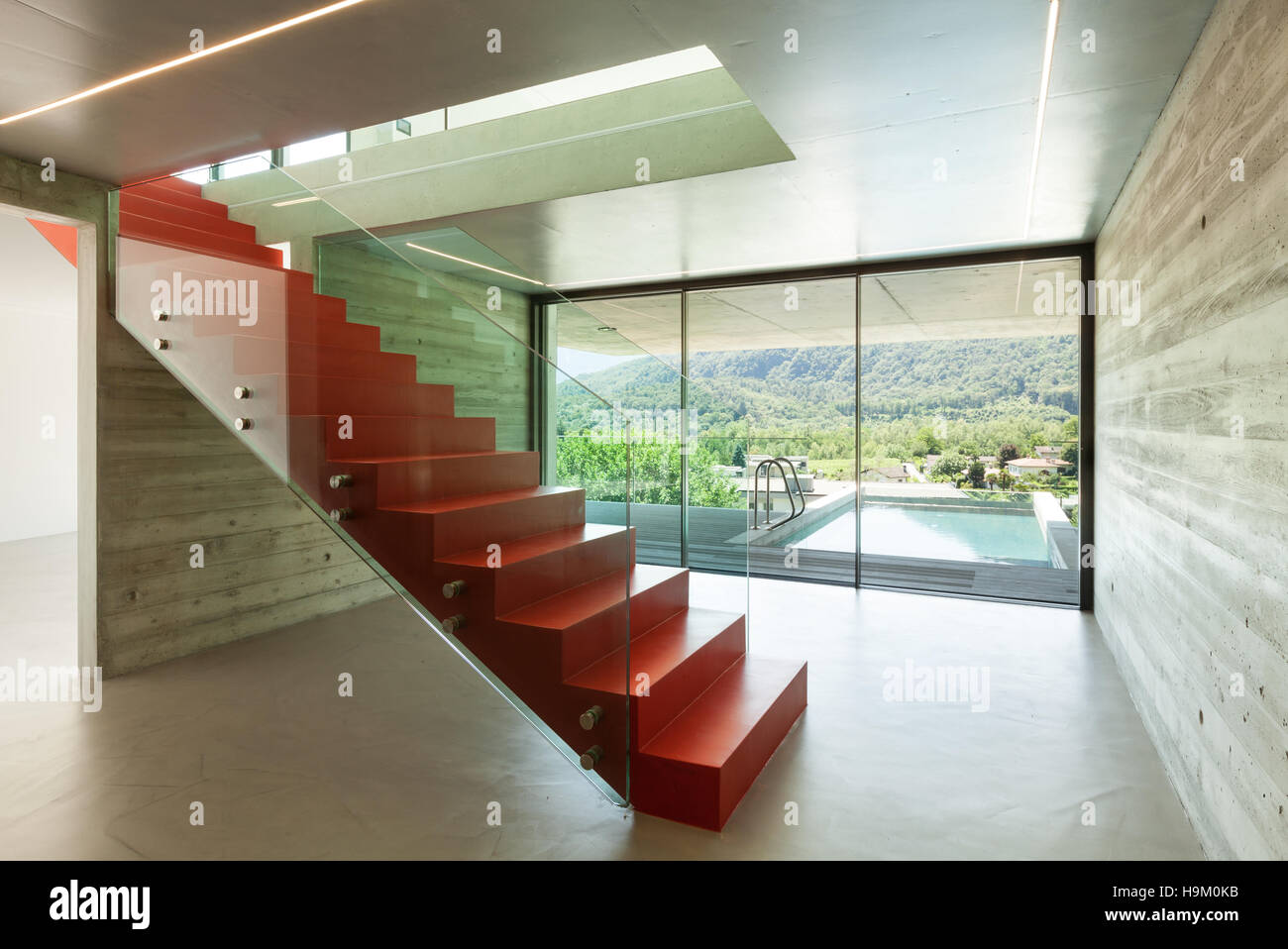 Interior, red staircase in modern villa Stock Photo - Alamy