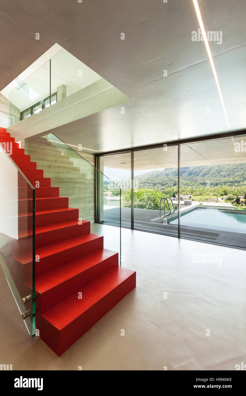 Interior, red staircase in modern villa Stock Photo - Alamy