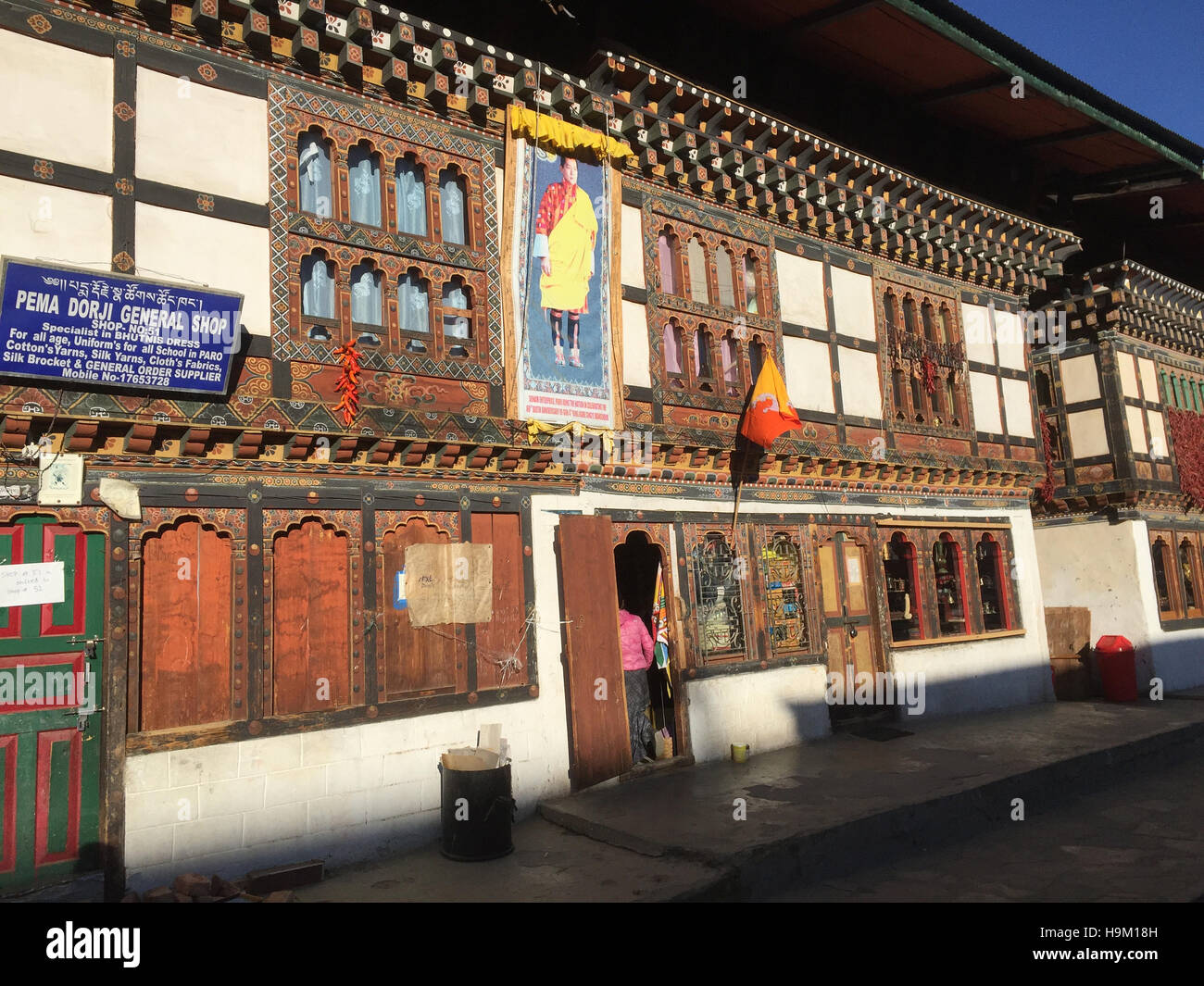 BHUTAN Shops on the main street in the capital Thimpu with the King's ...