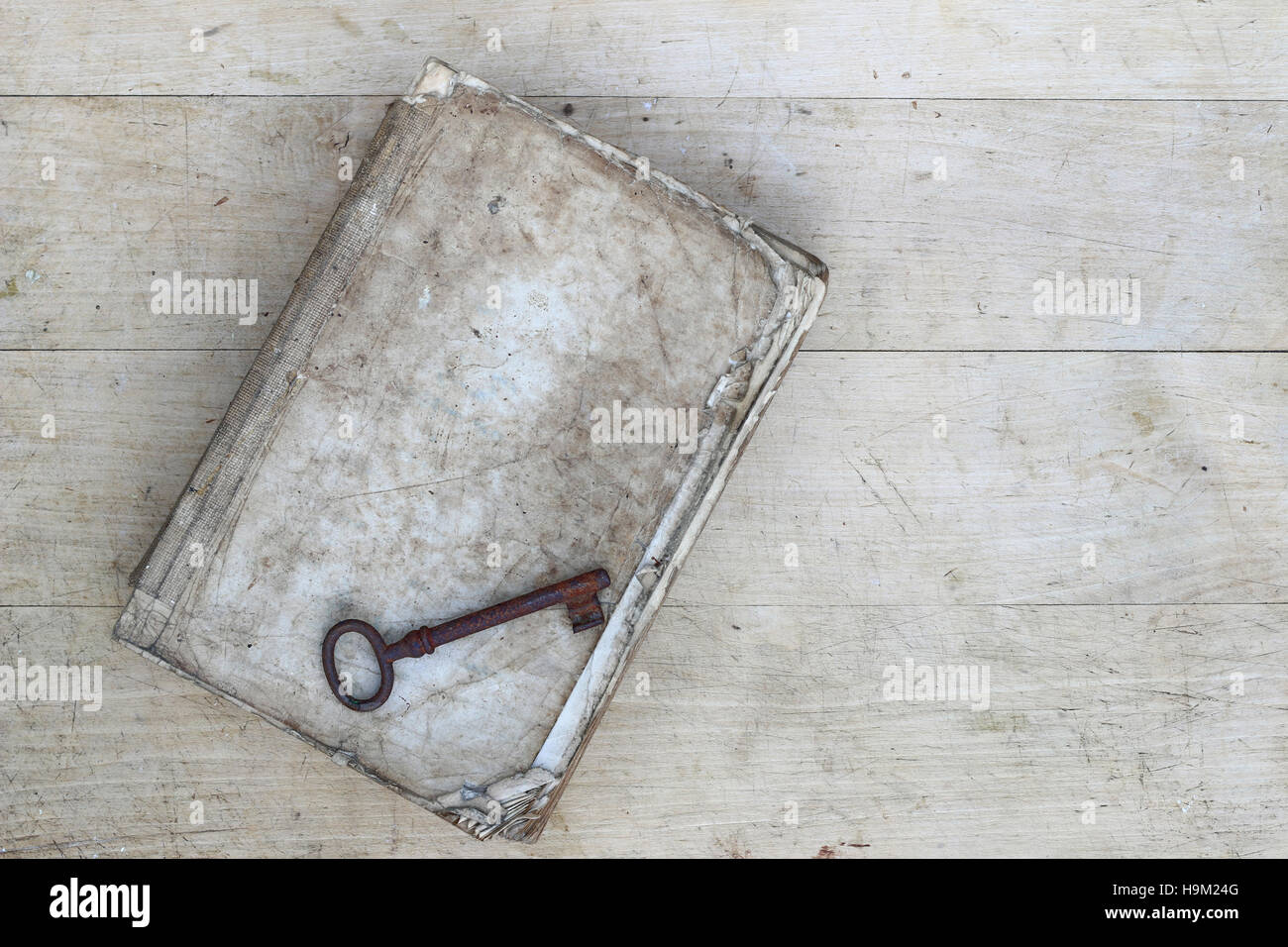 Old rusty key on torn book Stock Photo - Alamy