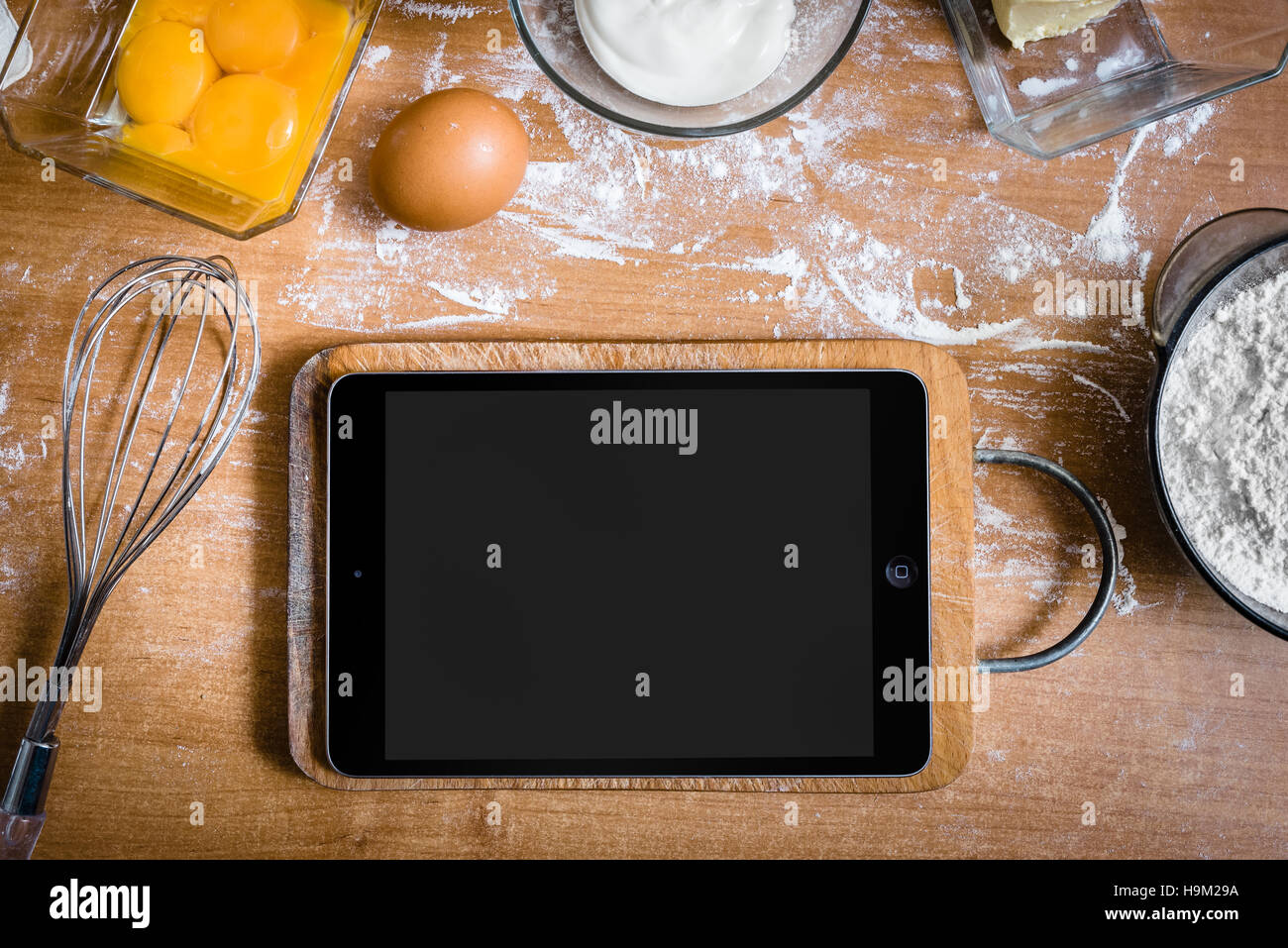 Tablet on the kitchen table Stock Photo - Alamy