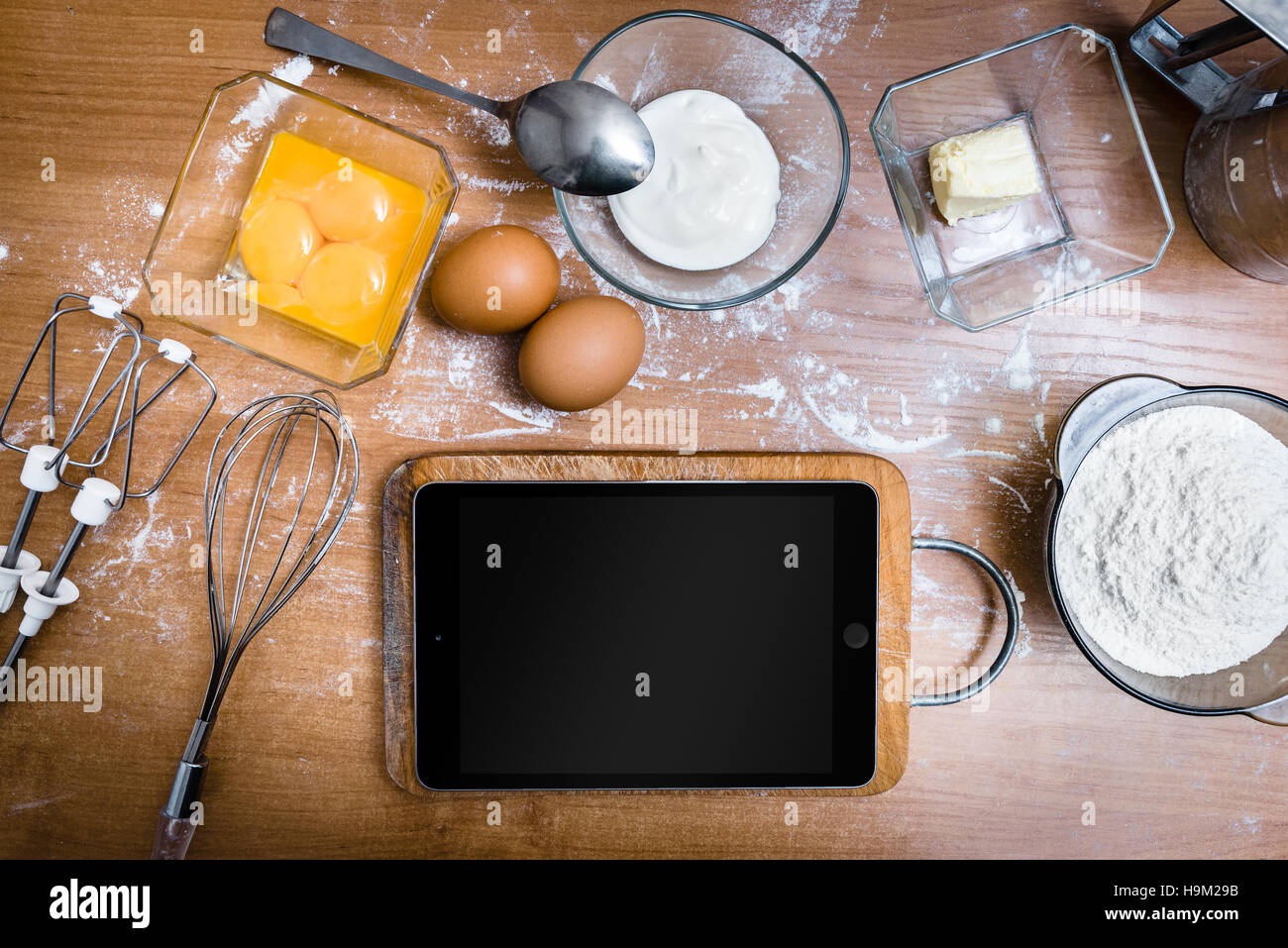 Tablet on the kitchen table Stock Photo - Alamy