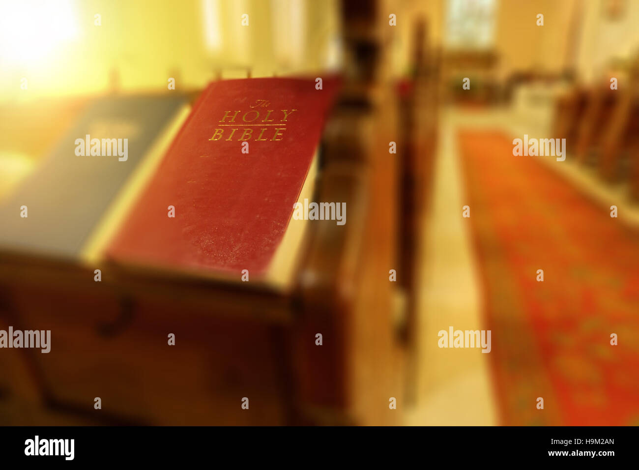 Abstract picture of holy bible with blurred church background with sun ...
