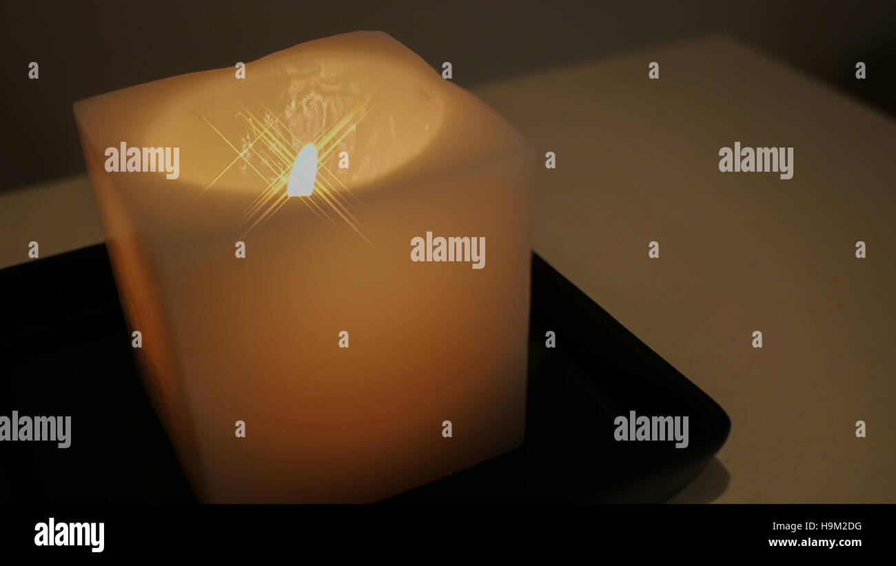 One white candle glowing in dim light Stock Photo - Alamy